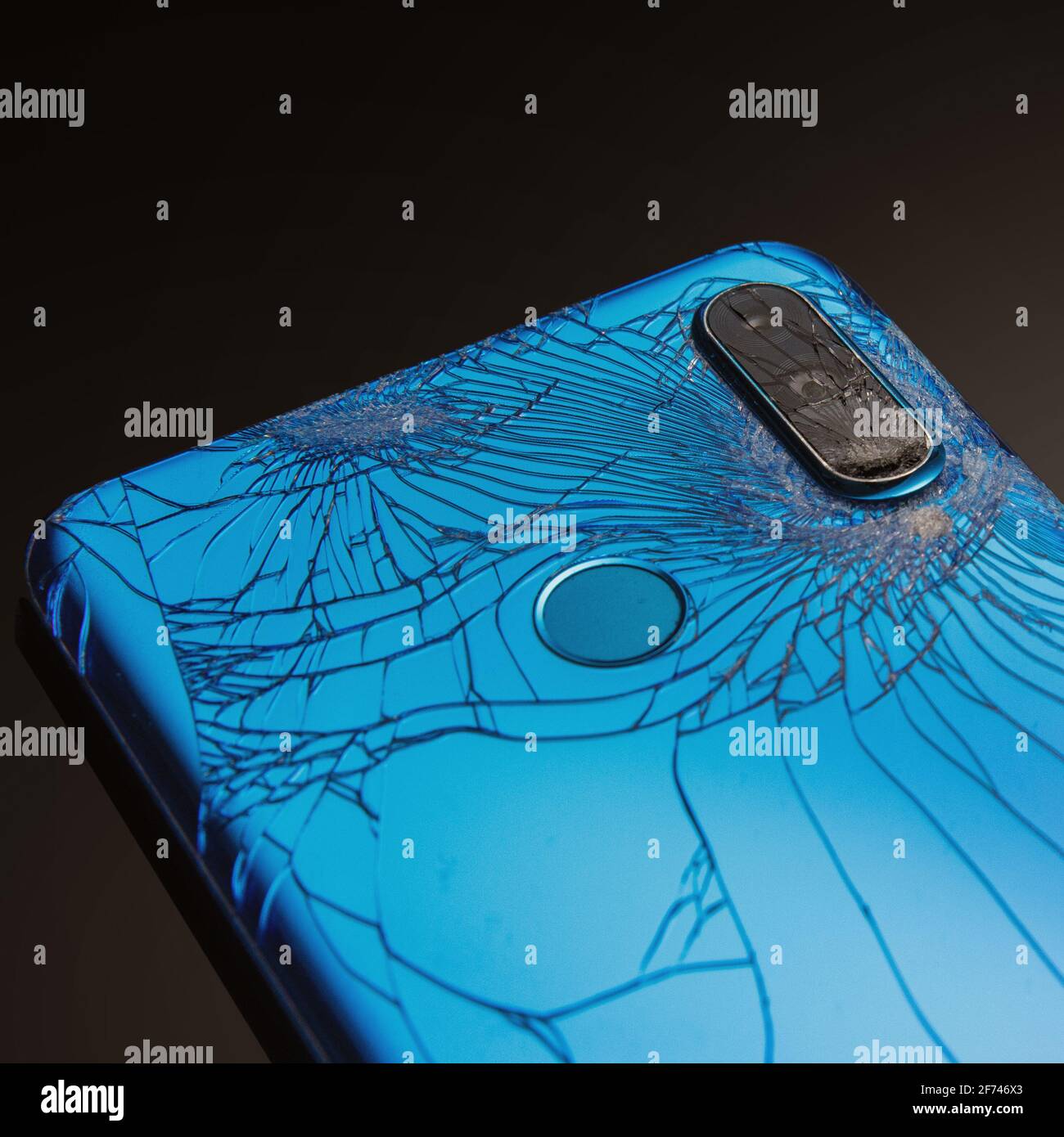 The back side of a broken phone. Spoiled smartphone camera Stock Photo ...