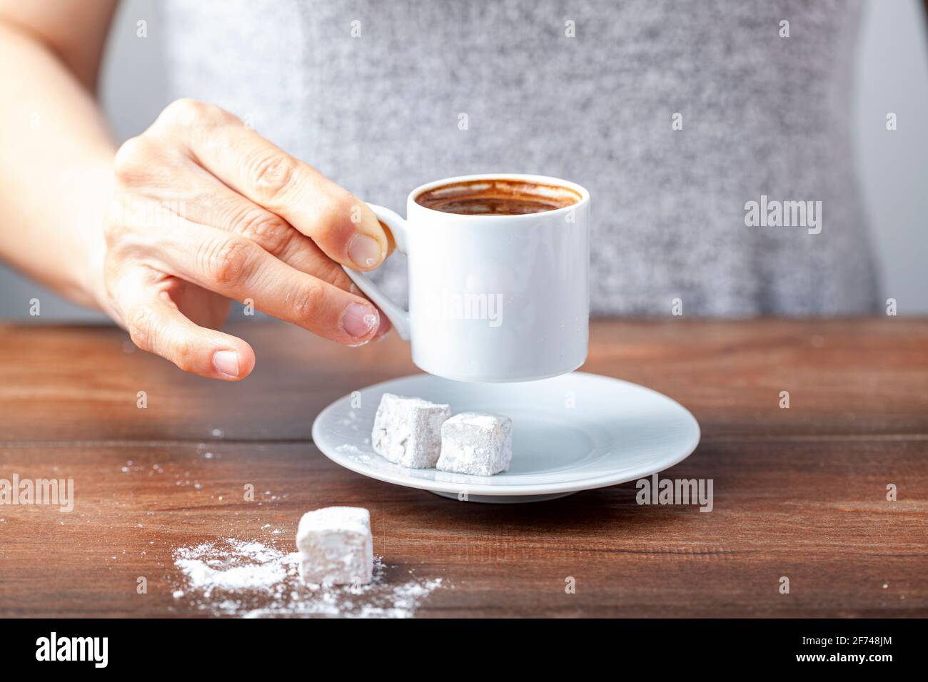 A caucasian Turkish woman is drinking traditional Turkish coffee from ...