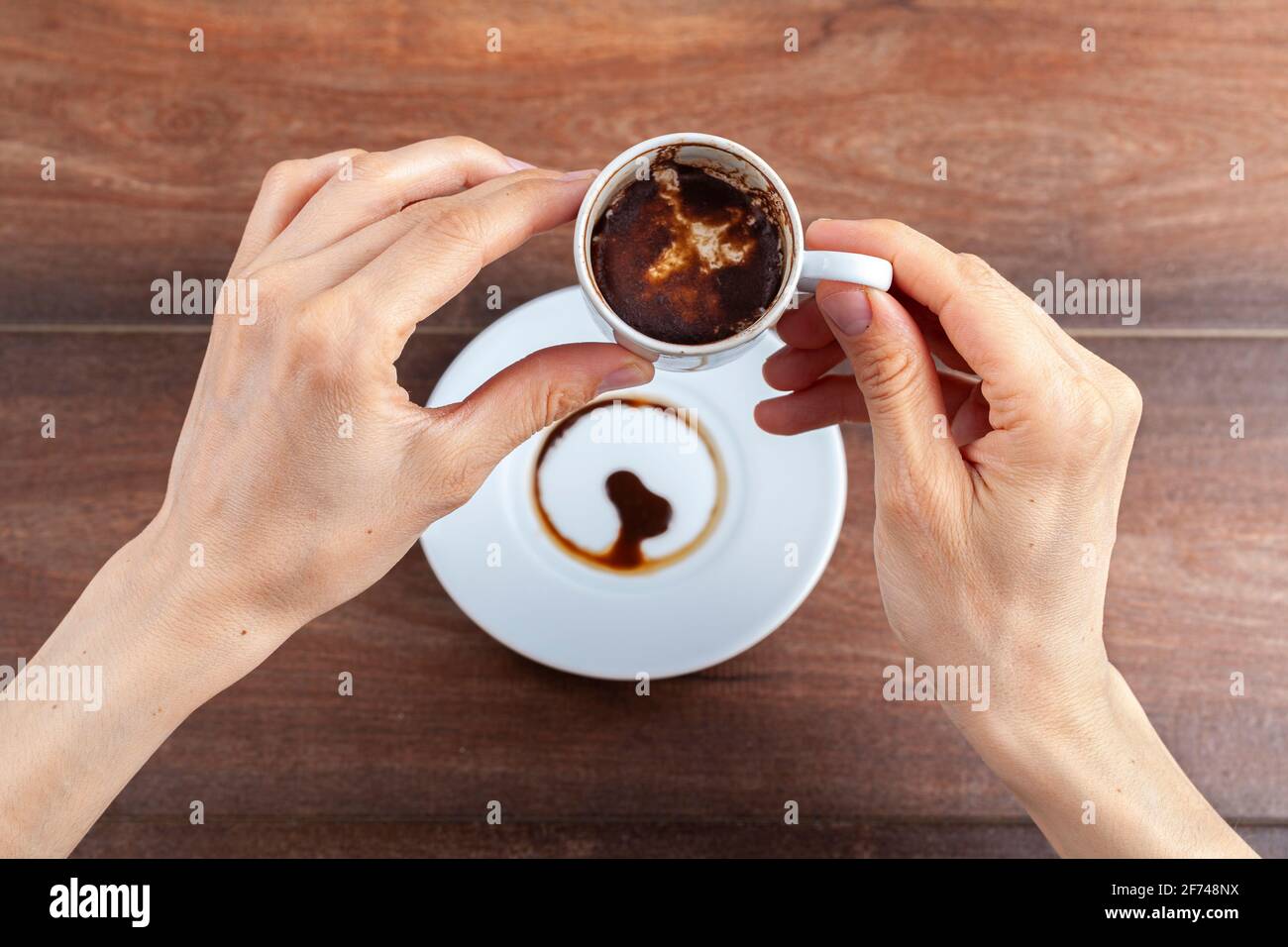 A caucasian woman is performing fortune reading ( kahve fali ) using ...