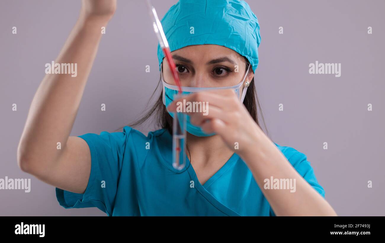 Female doctor examines a blood sample Stock Photo - Alamy