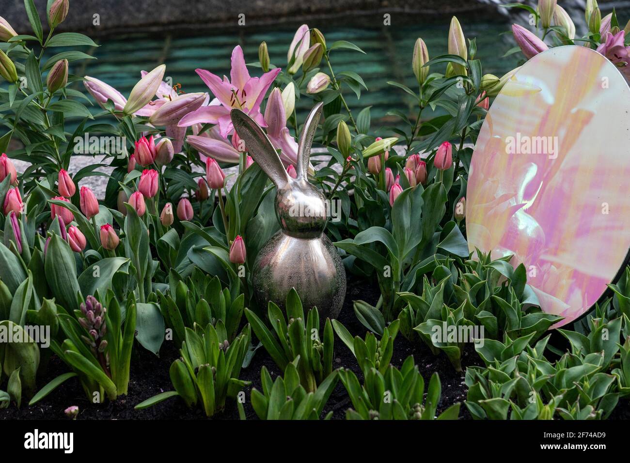 Easter garden with lilies, tulips, daffodils, daisies, bluebells ...