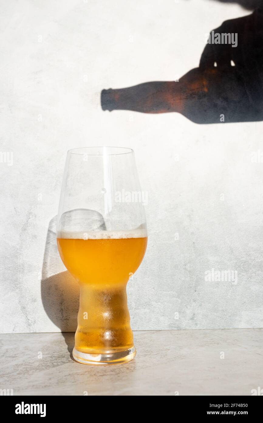 Serving beer, from a bottle to a crystal glass for IPA Stock Photo - Alamy