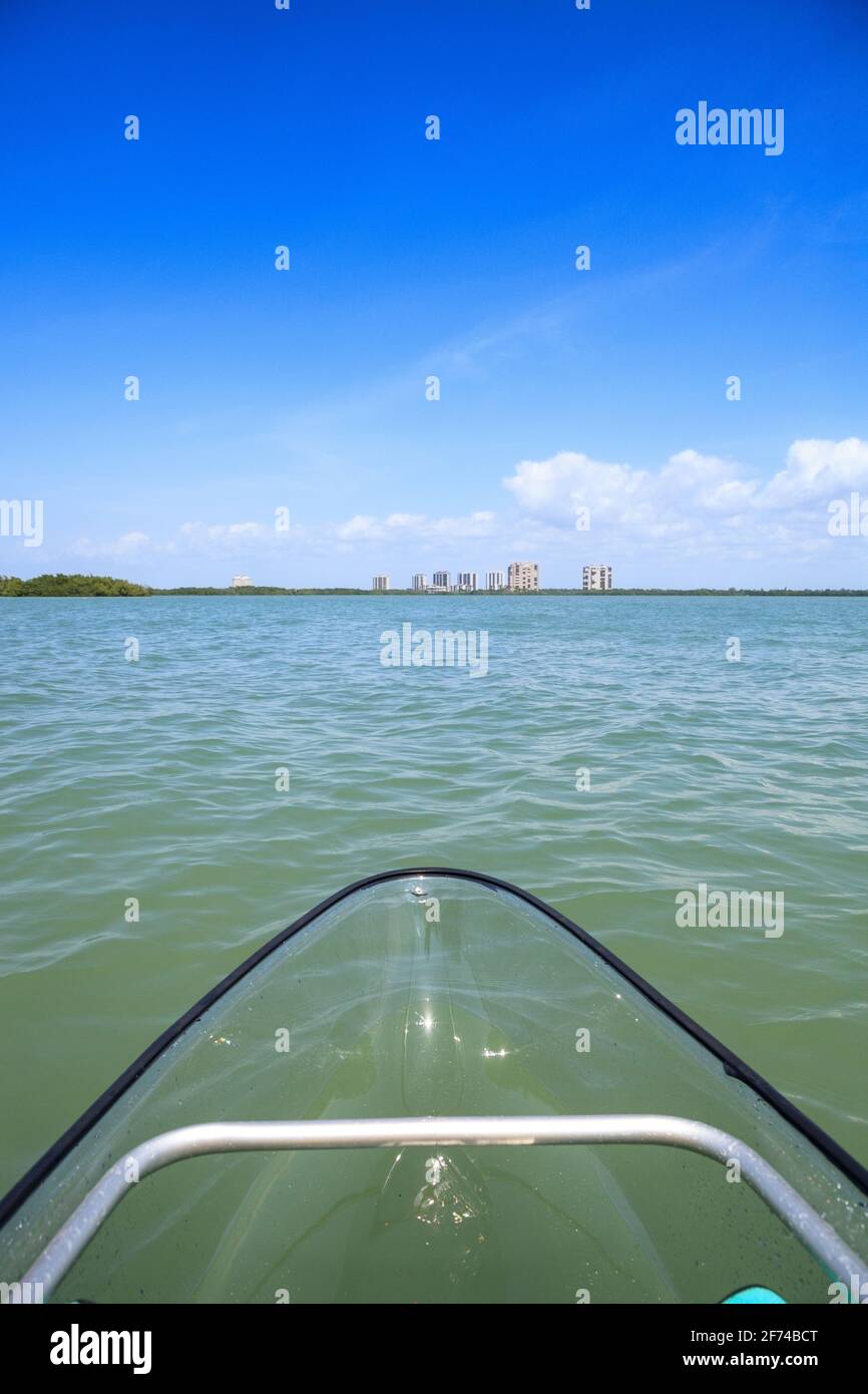 Clear kayak forges through the waterway of Lovers Key in Bonita Springs ...