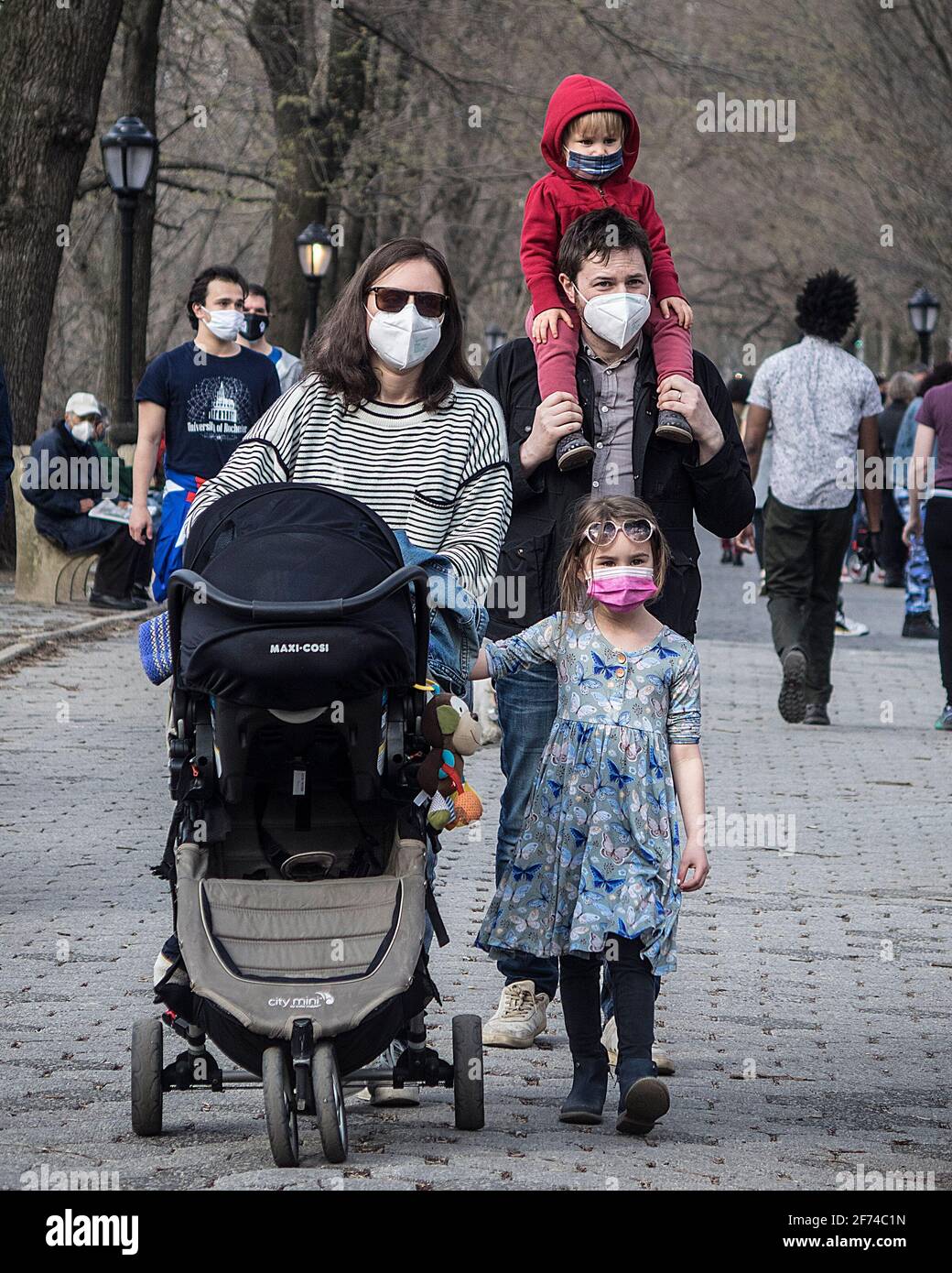 New York, New York, USA. 4th Apr, 2021. A family wearing masks walk in ...