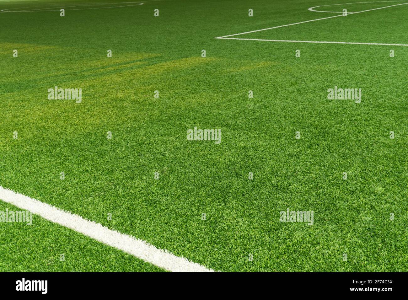 green artificial grass footballor soccer field with white line Stock ...