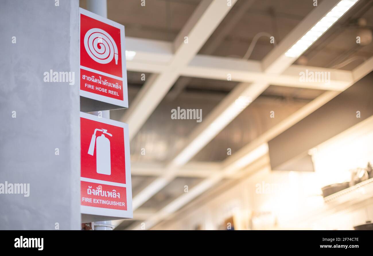 Red fire alarm sign on the white wall for safety first and sign for ...
