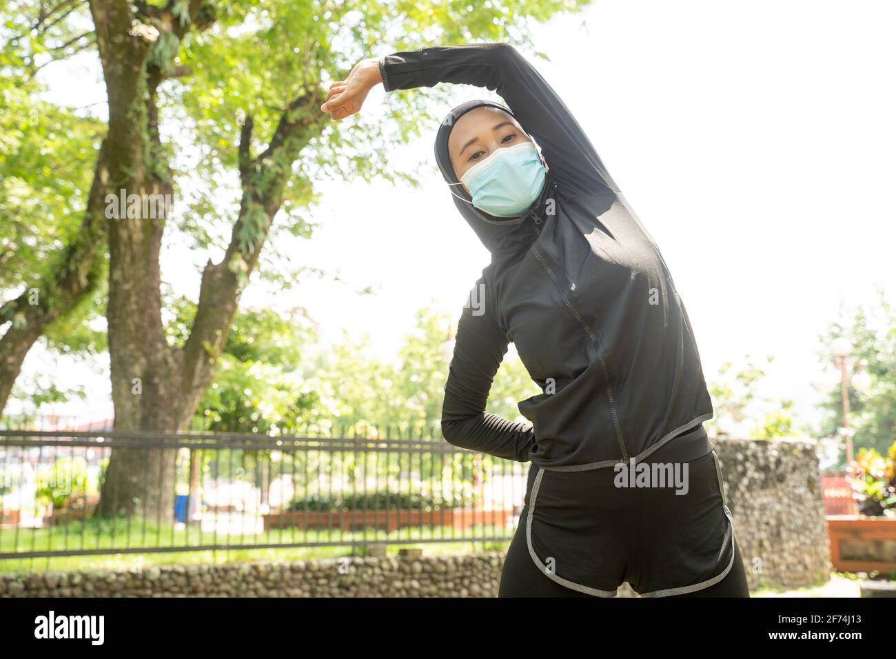 muslim woman athlete stretching and exercising her body outdoor Stock ...
