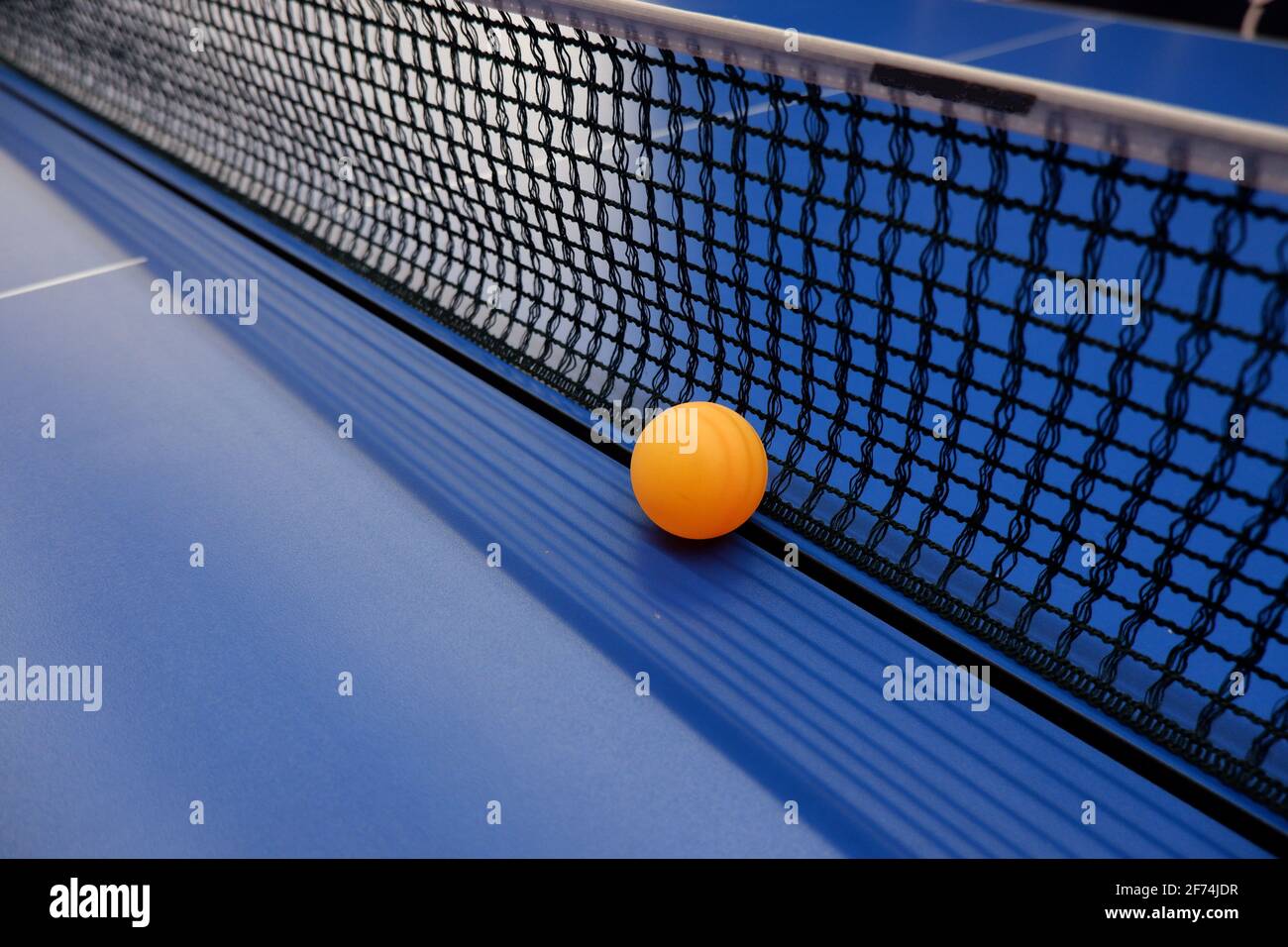 a tennis ball lies near the table tennis net on the tennis table Stock ...