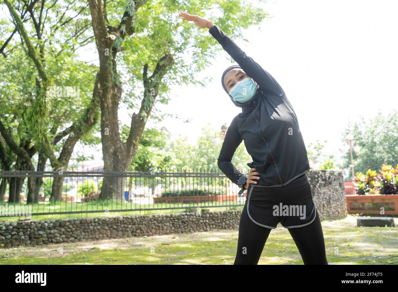 muslim woman athlete stretching and exercising her body outdoor Stock ...