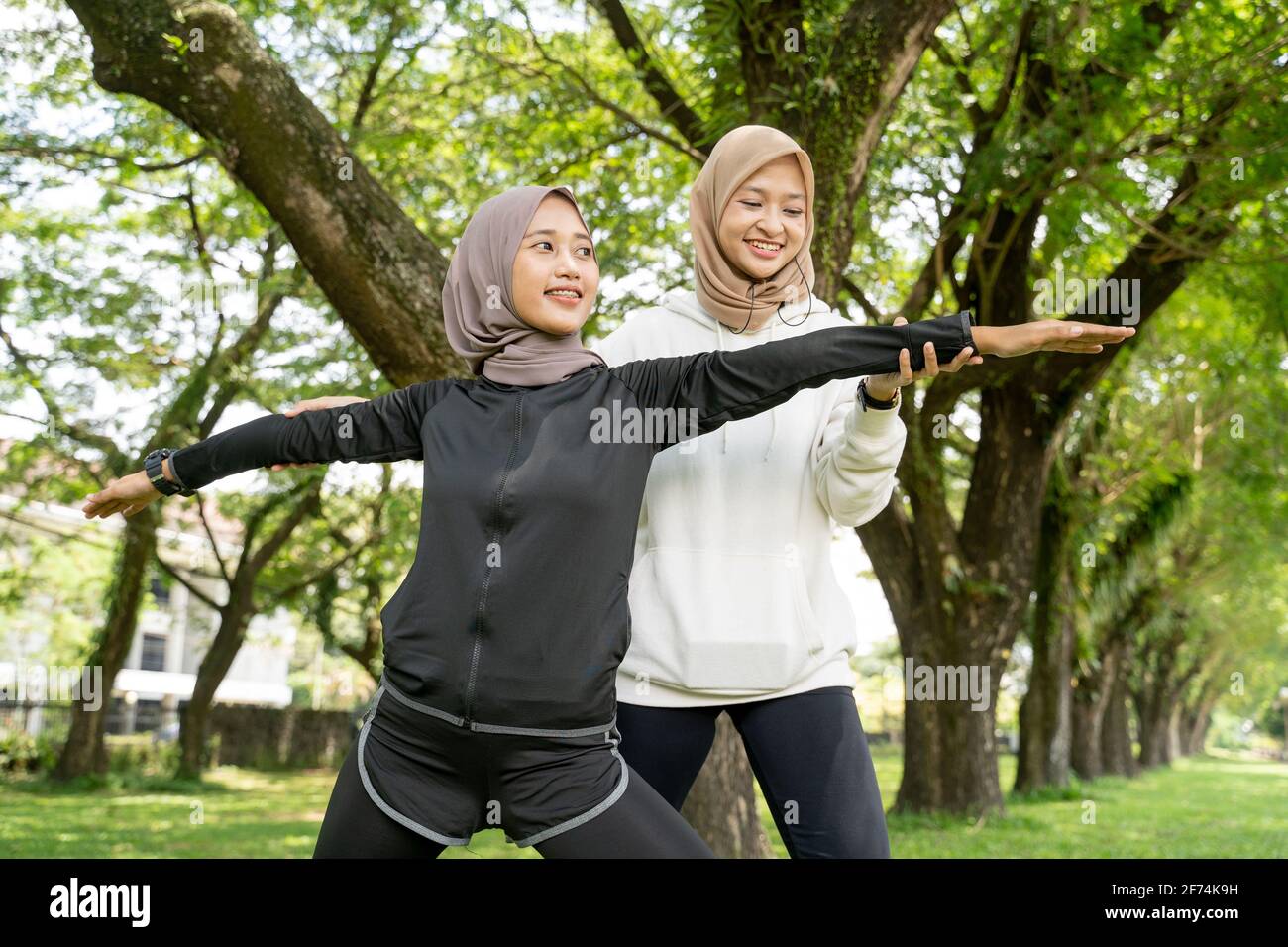 muslim with exercising partner doing sport together outdoor Stock Photo ...