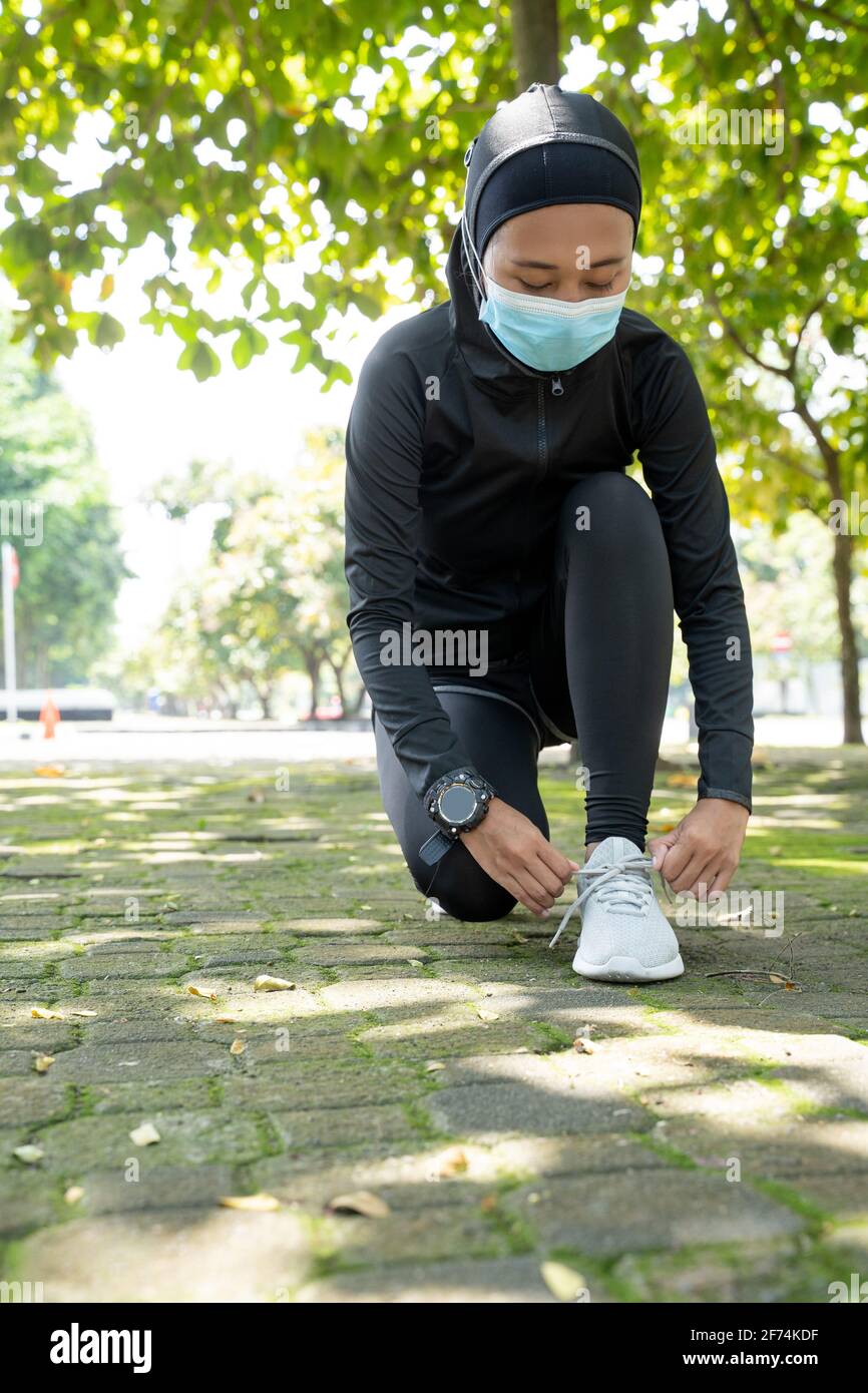 muslim woman athlete stretching and exercising her body outdoor Stock ...