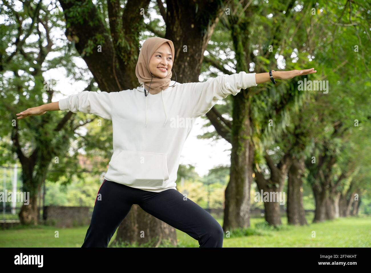 happy and fun muslim woman doing exercising outdoor in the morning ...