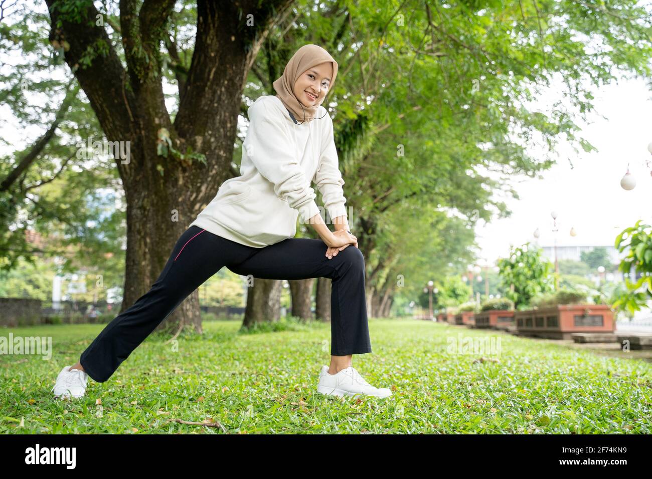 happy and fun muslim woman doing exercising outdoor in the morning ...