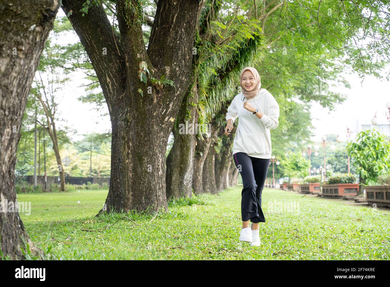 Muslim woman running hi-res stock photography and images - Alamy