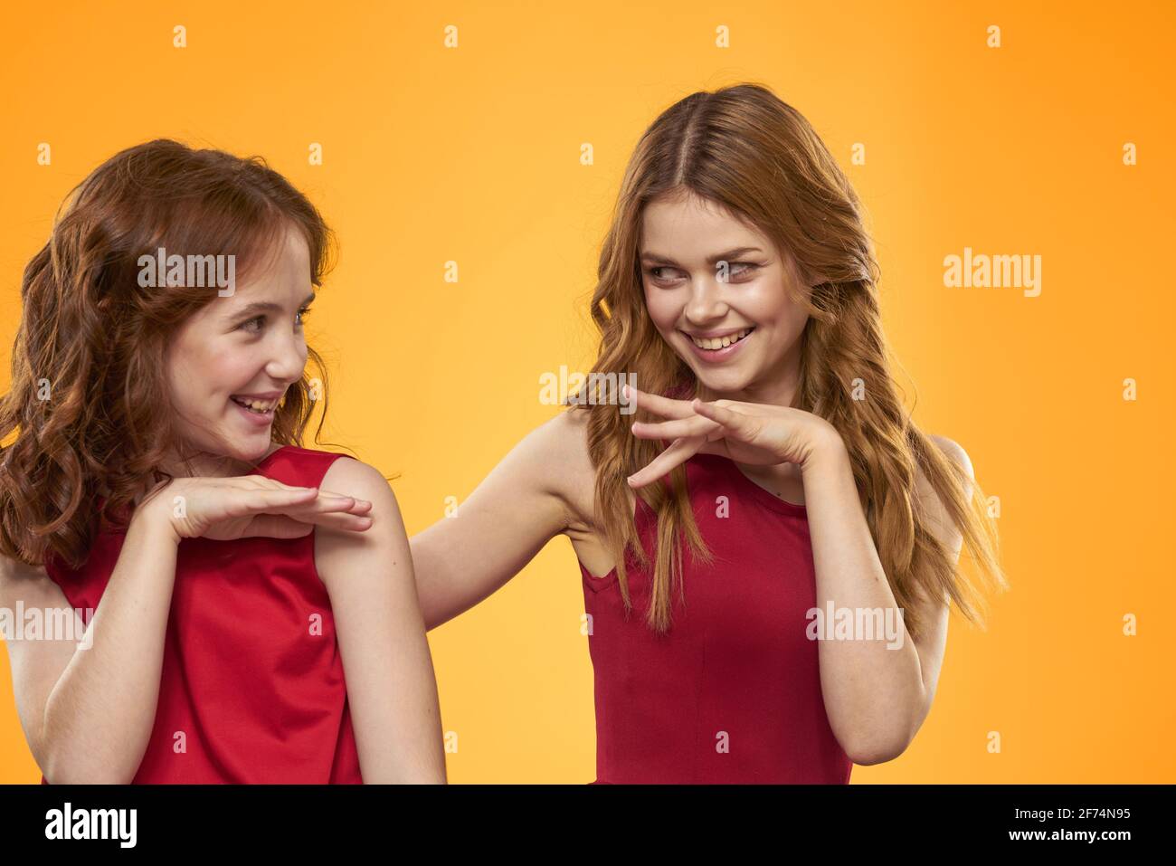 Mom and daughter in red dresses entertainment lifestyle yellow ...