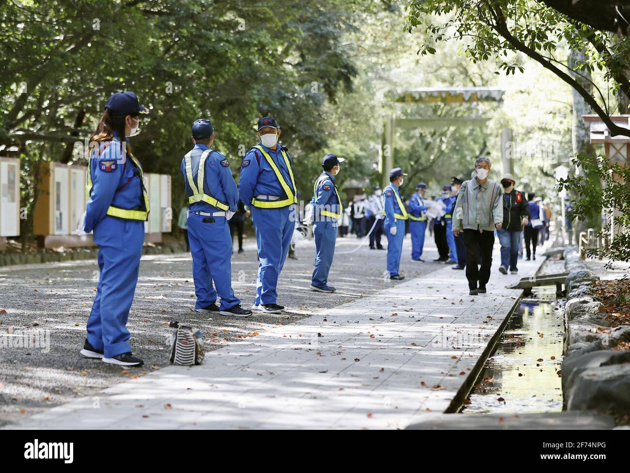 Security guards stand along a path leading to the main hall of Atsuta ...