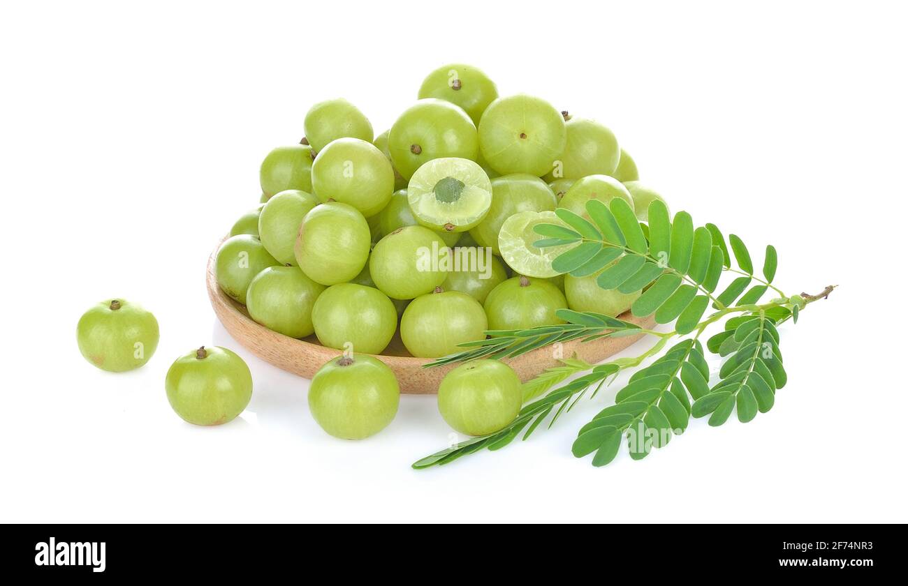 Indian gooseberry in wood bowl on white background Stock Photo - Alamy