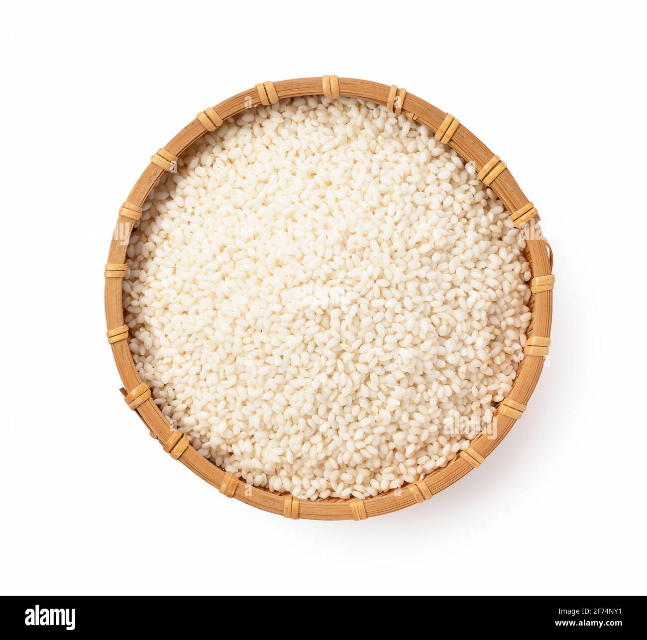 Glutinous rice in a bamboo colander on a white background. View from ...