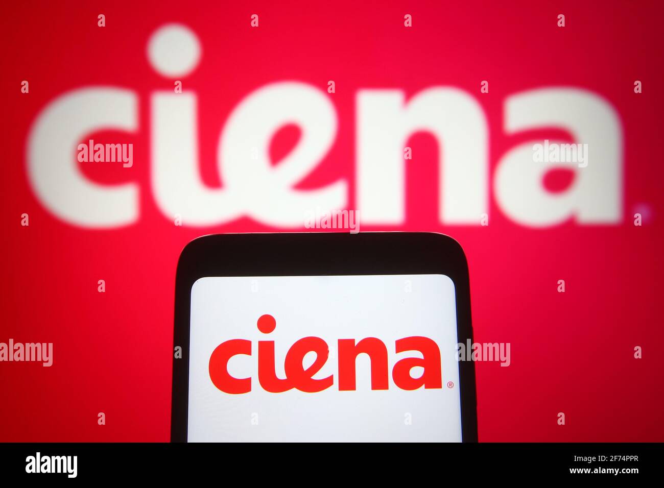 In this photo illustration the Ciena logo is seen on a smartphone and a ...