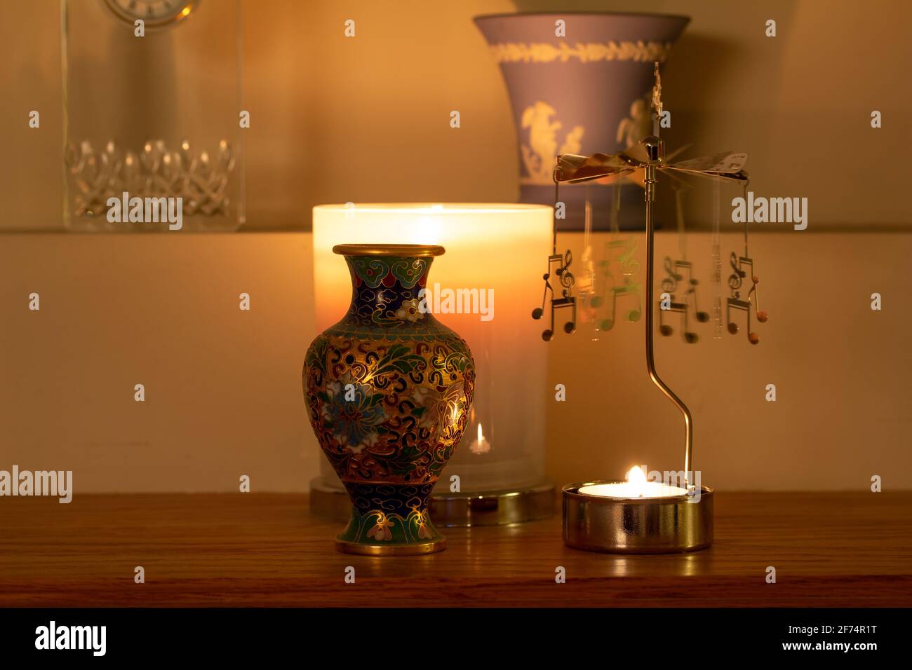 Abstract view of an interior fireplace mantel shelf of small candle lit ...
