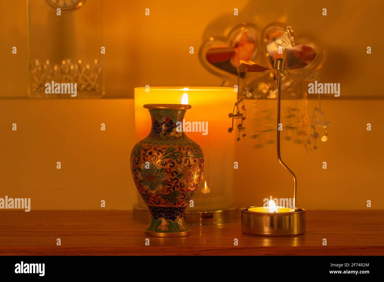 Abstract view of an interior fireplace mantel shelf of small candle lit ...