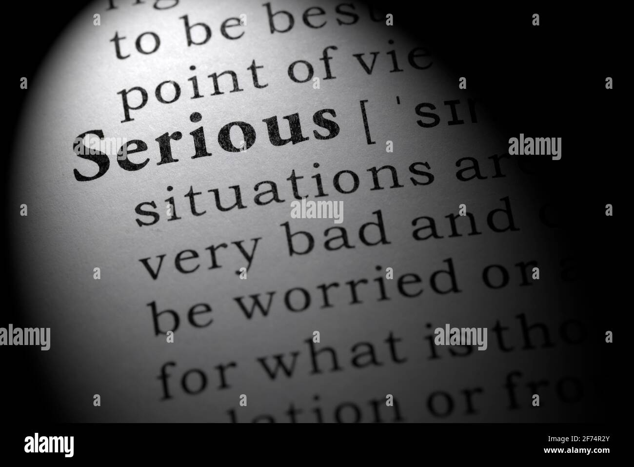 Fake Dictionary, Dictionary definition of serious Stock Photo - Alamy