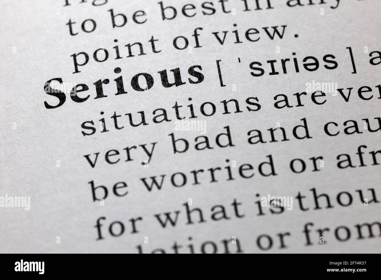 Fake Dictionary, Dictionary definition of serious Stock Photo - Alamy