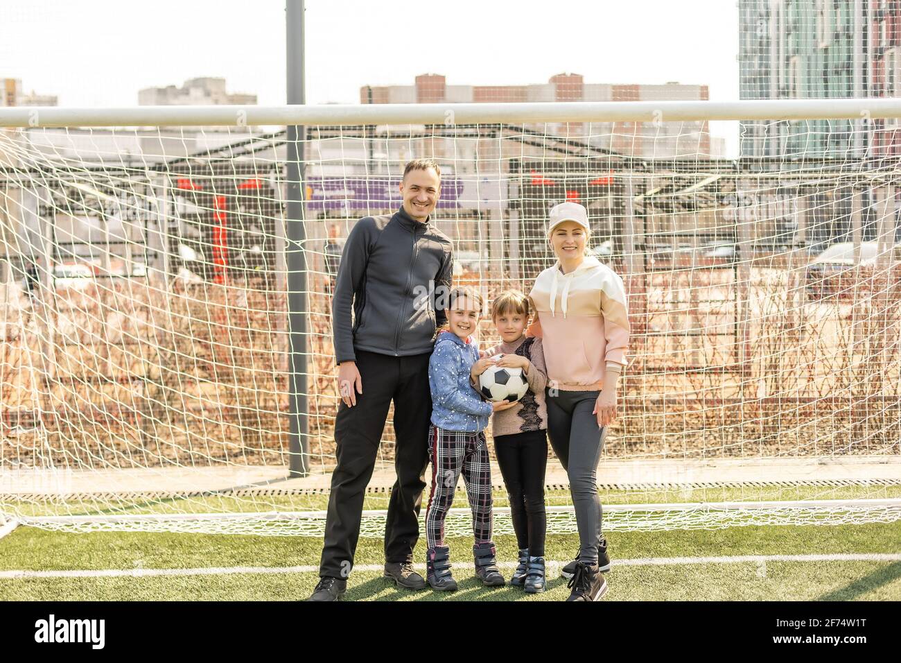 family with soccer ball in stadium Stock Photo - Alamy