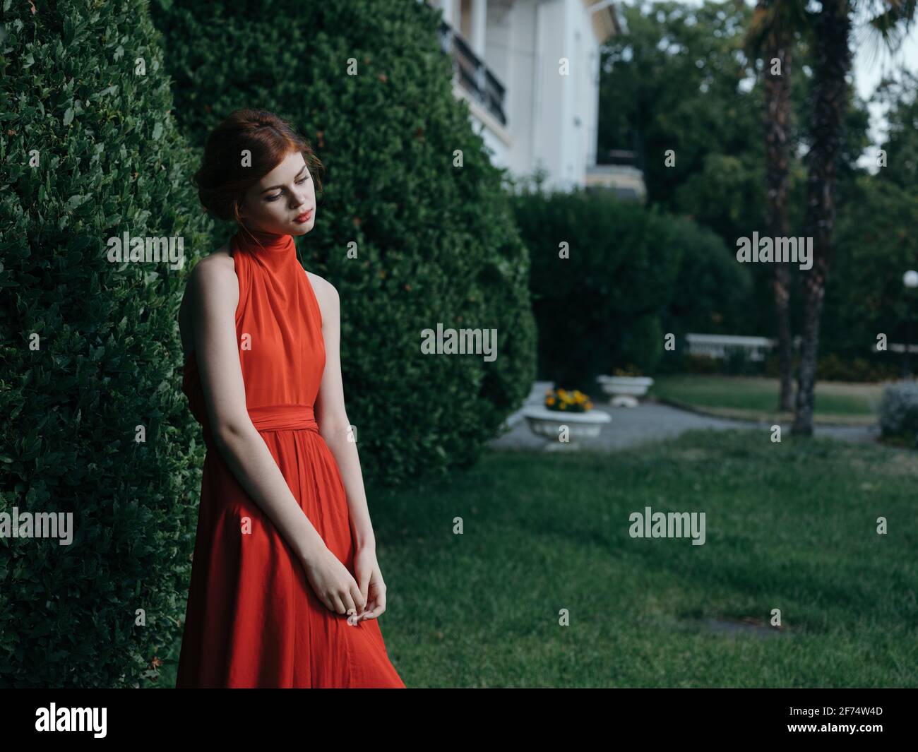 Pretty woman red dress Masquerade walk gothic style Stock Photo - Alamy
