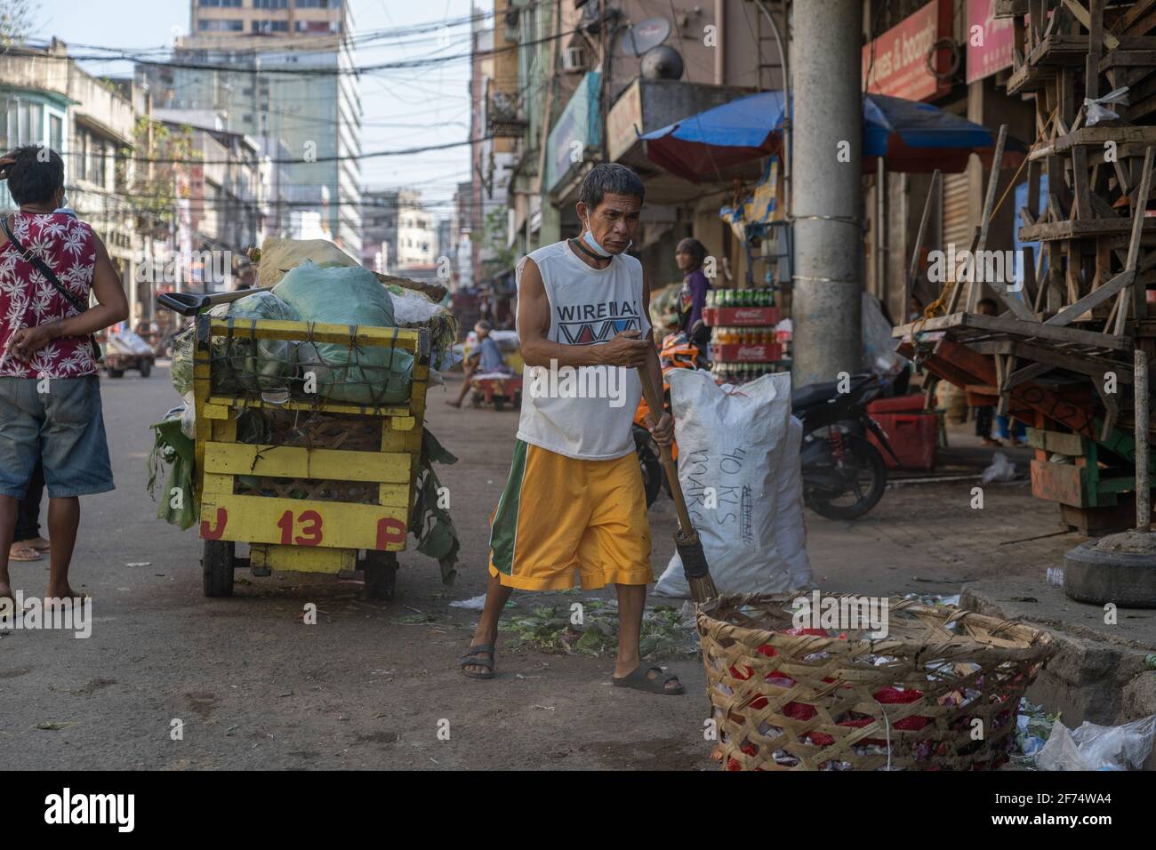 A street cleaner in a market area, Cebu City, Philippines Stock Photo ...
