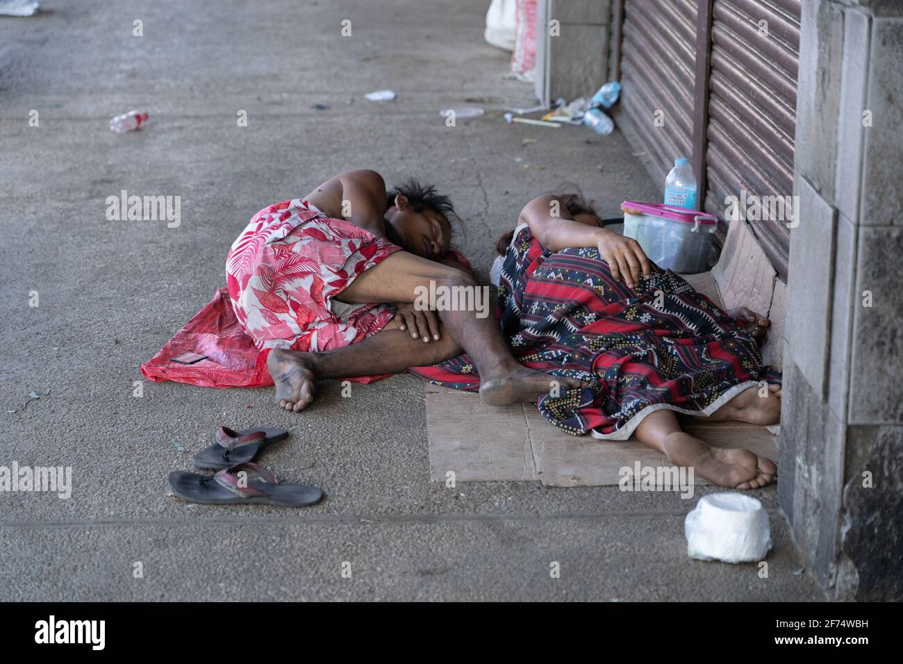 Two homeless people sleeping on a sidewalk within a poor area, Cebu ...