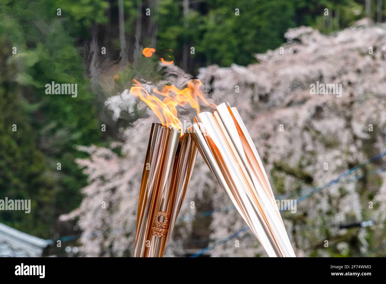 Local torchbearers pass the Olympic flame at Tsumago-juku area during ...