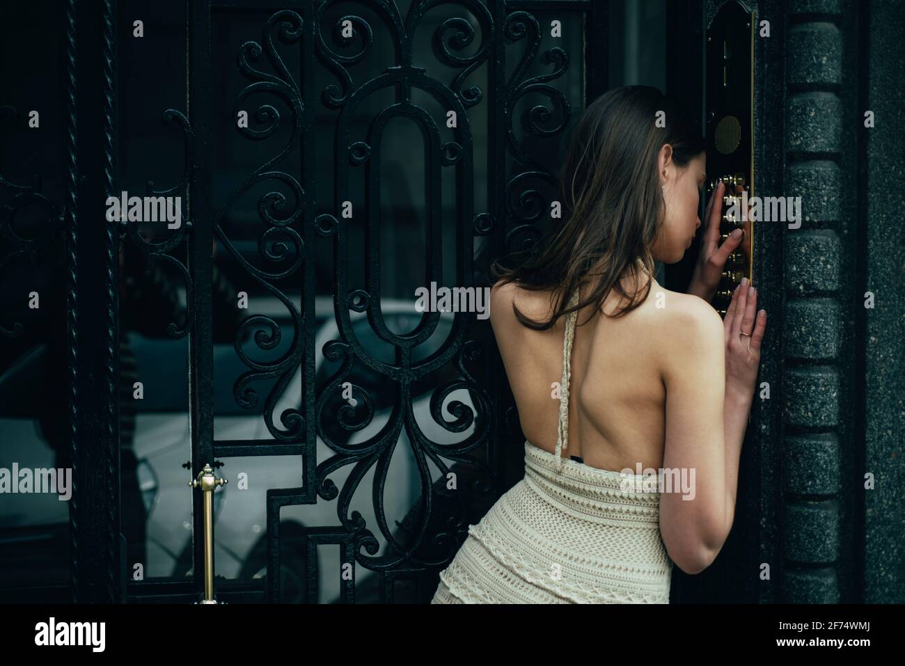 Safety female intercom button doorbell at building entrance. Young ...