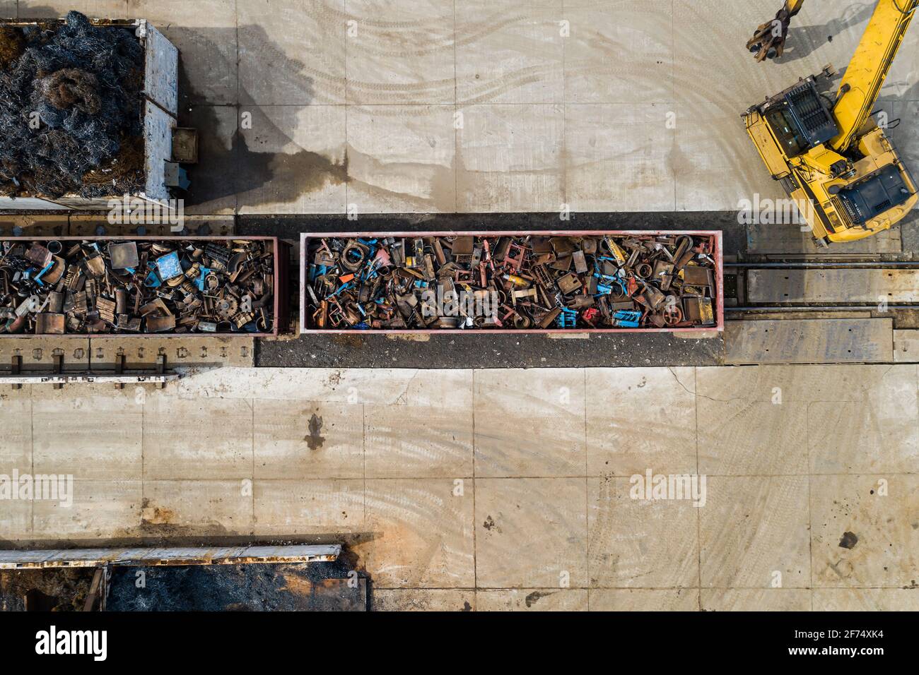Scrap metal recycling loading into containers top view from the throne ...