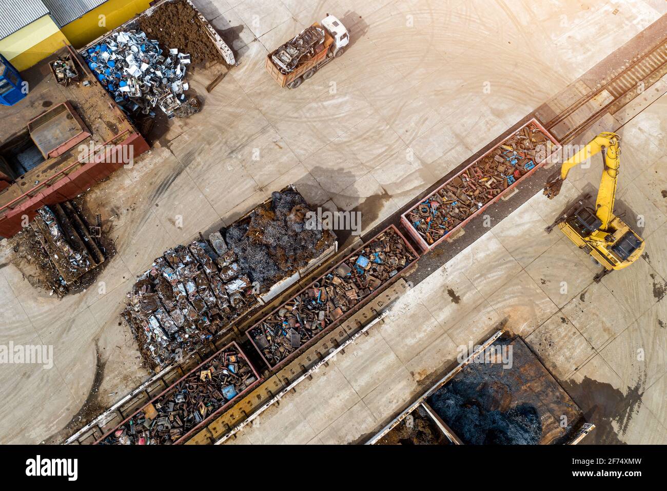 Scrap metal recycling loading into containers top view from the throne ...