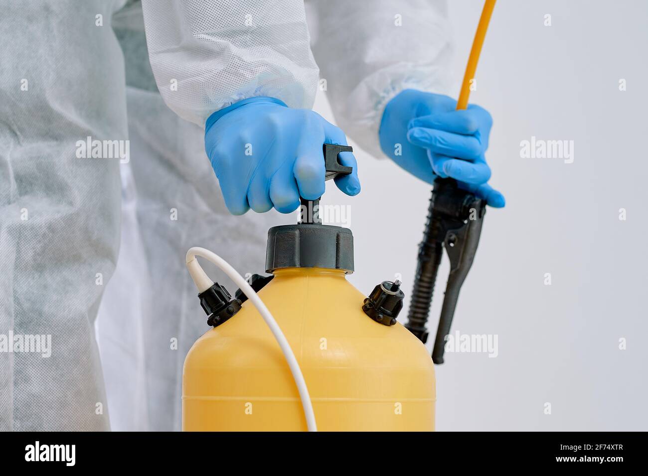 decontamination service worker using a container of disinfectant Stock ...