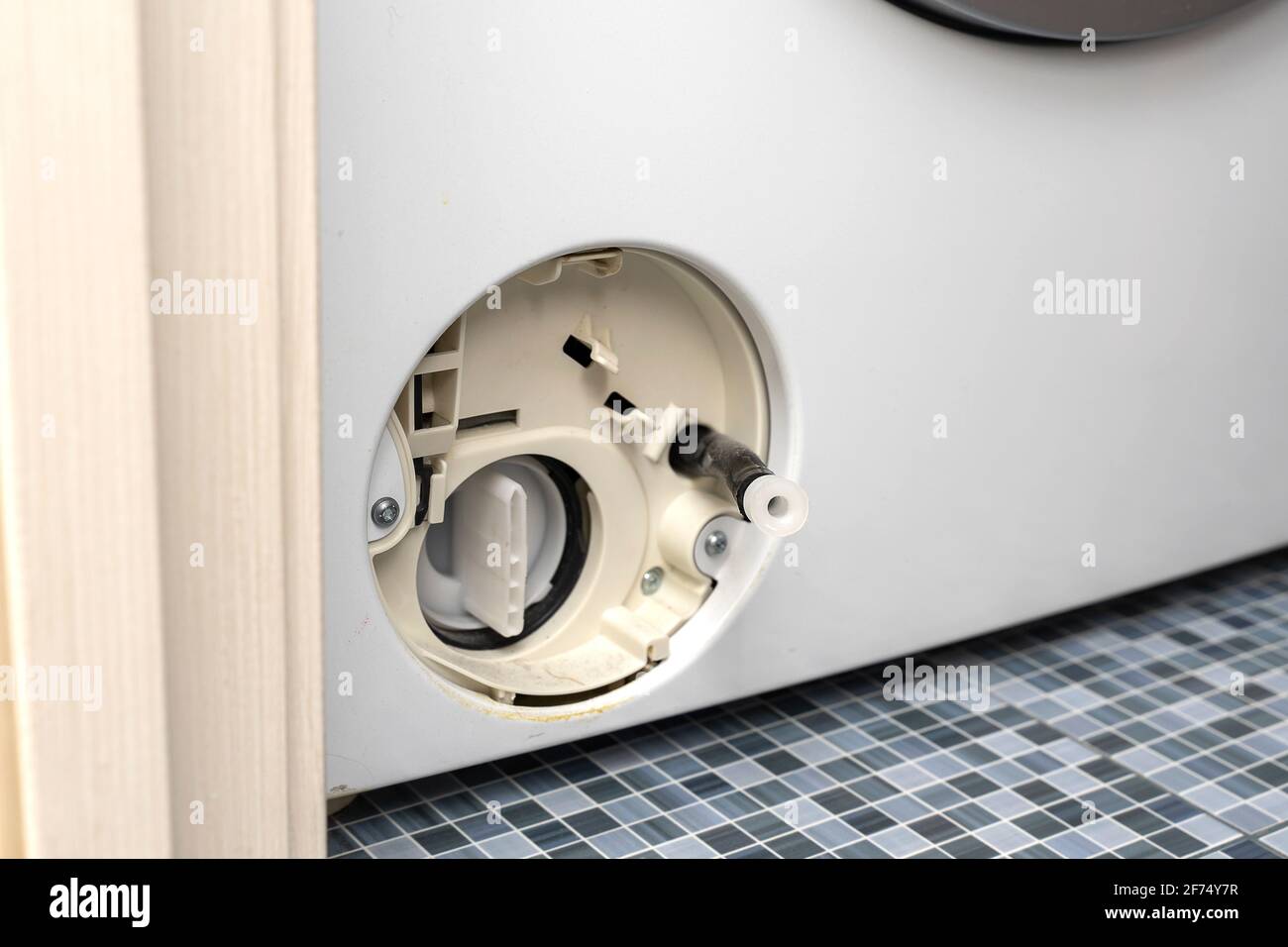 the filter of the washing machine is clogged. Open filter cover of ...