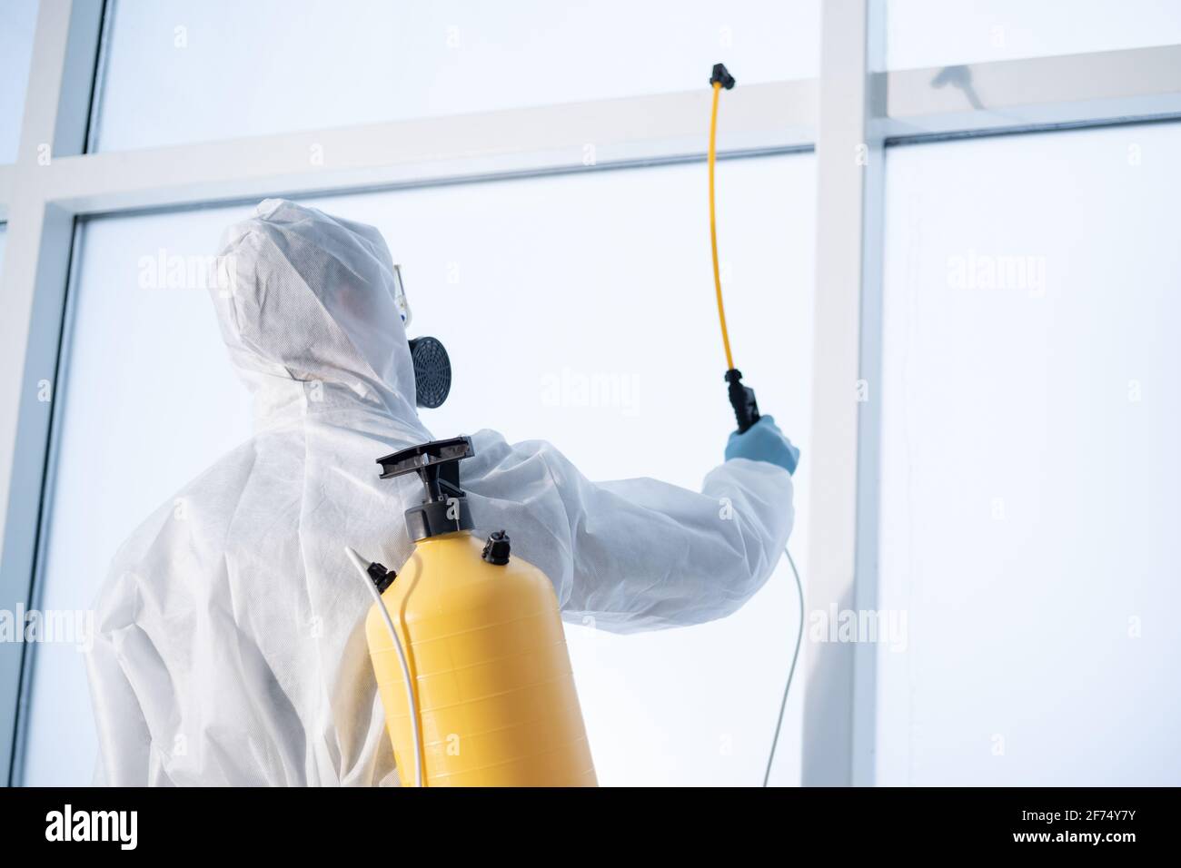 employee of a cleaning company disinfects the premises Stock Photo - Alamy