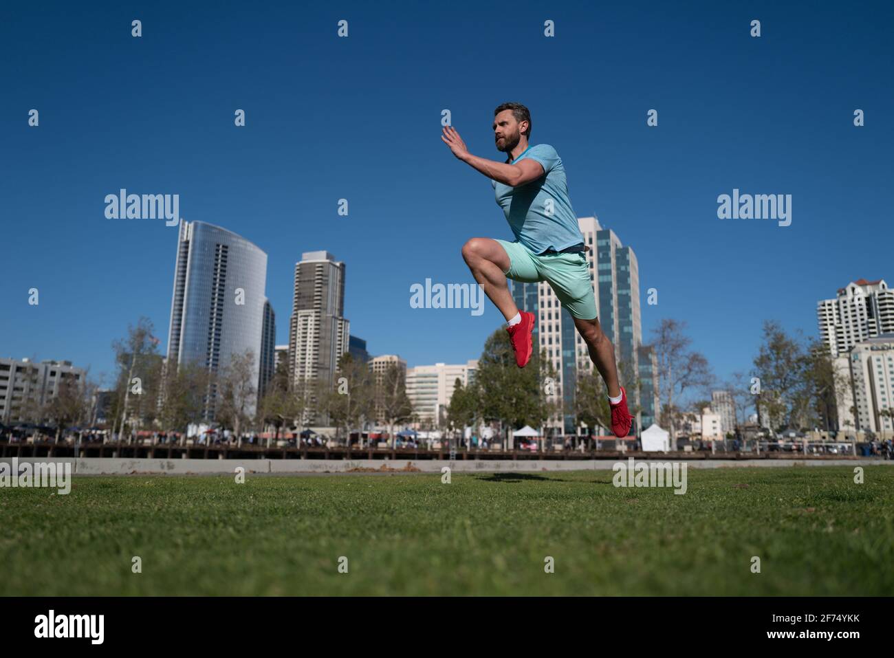 Athletic young man running in the nature. Dynamic movement Stock Photo ...