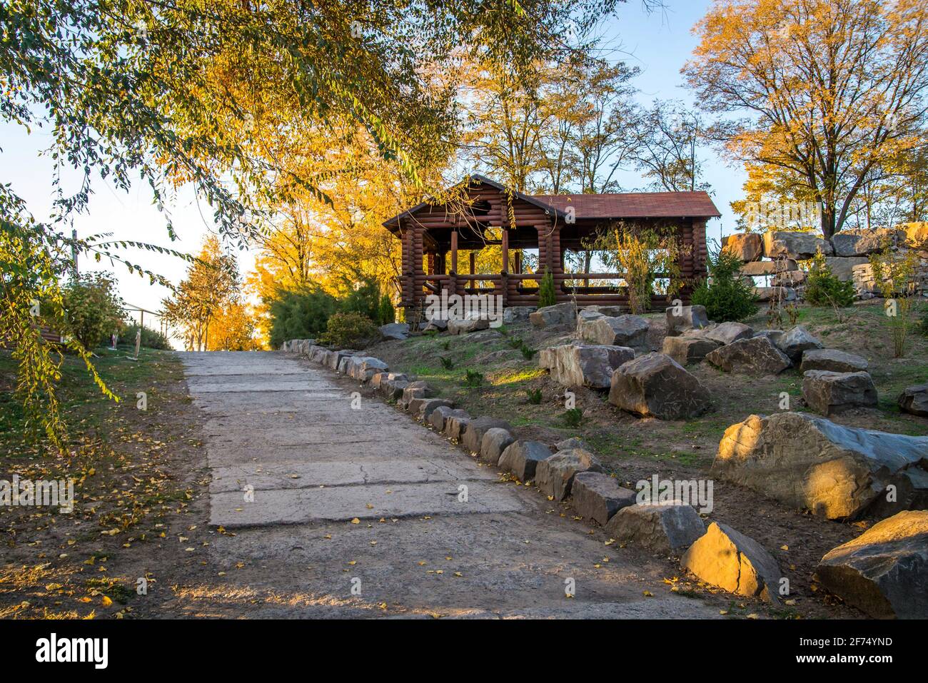 Autumn view of riverside park with wooden houses and benches Stock ...