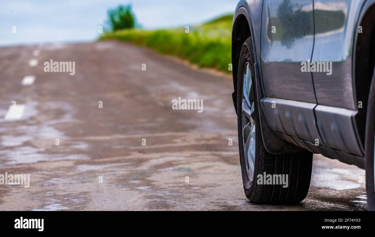 Car by the asphalt road wide and far view Stock Photo - Alamy