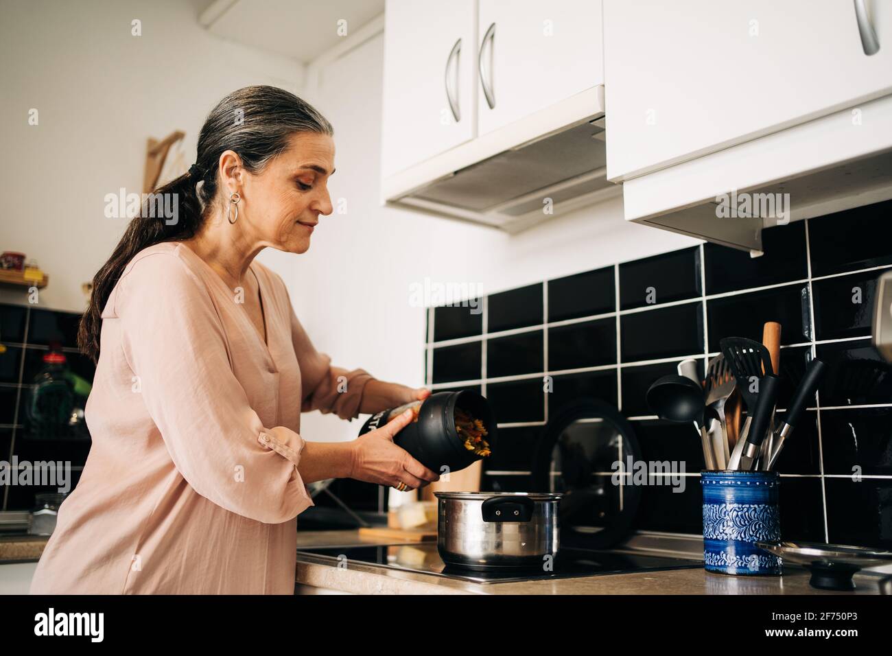 Adding to the food cupboard hi-res stock photography and images - Alamy