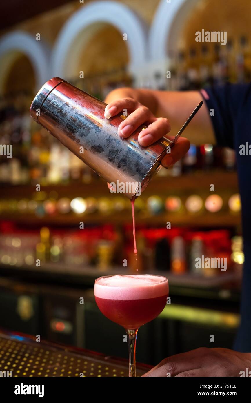 Detail of unrecognizable bartender's hand working in the bar with his ...