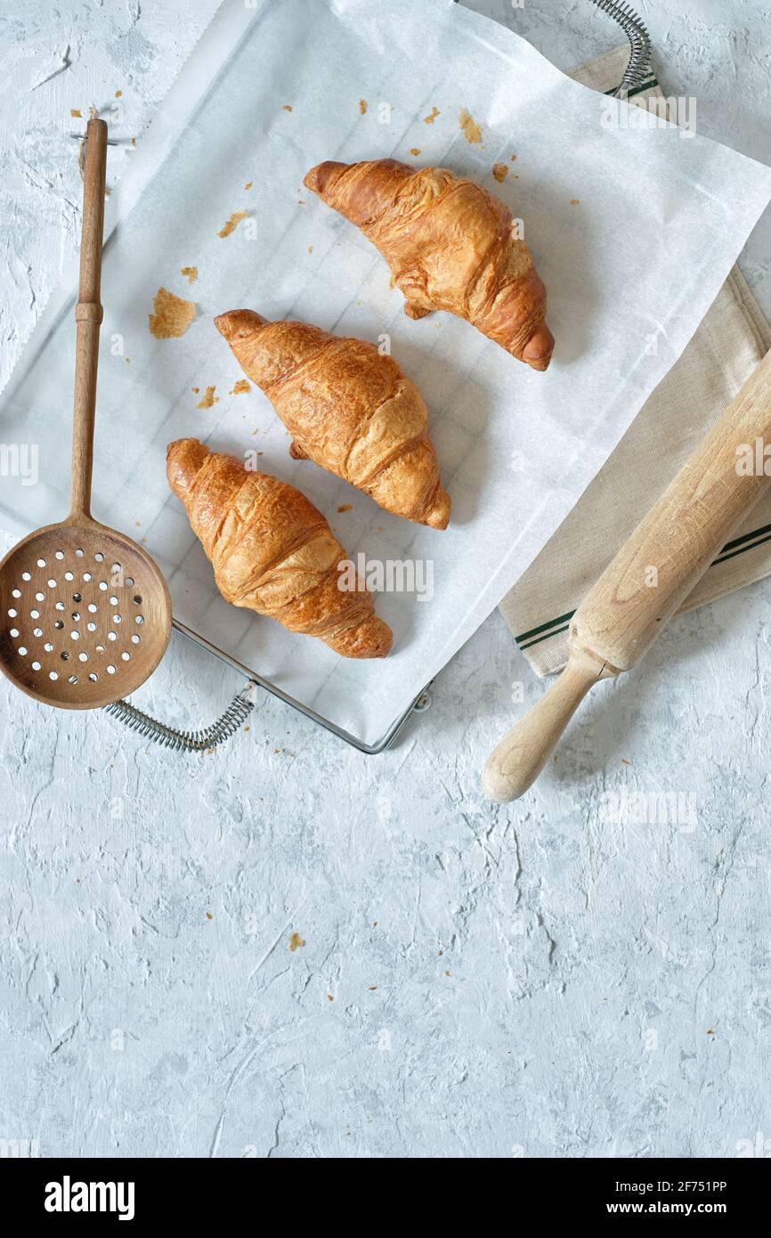 Top view of yummy fresh croissants placed on metal tray on table in ...