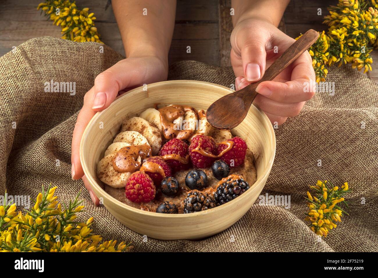 Crop anonymous cook showing bowl with banana slices and assorted fresh ...