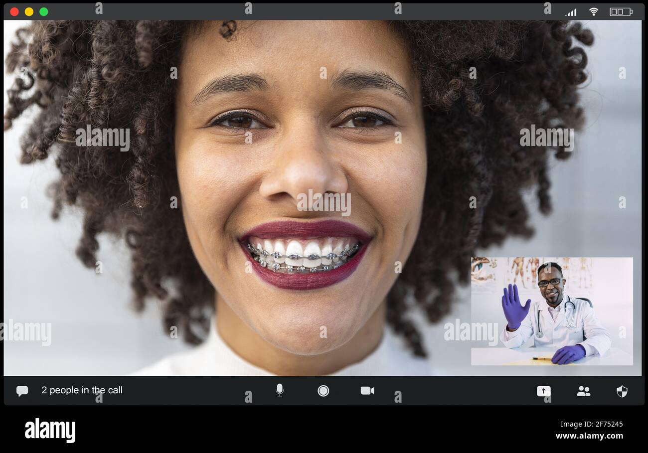 Crop cheerful African American female patient with braces smiling at ...