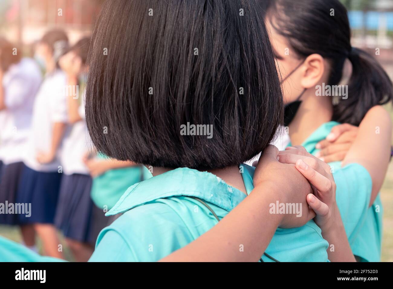 Concept of best friends,Teen group of uniform students hugging in ...