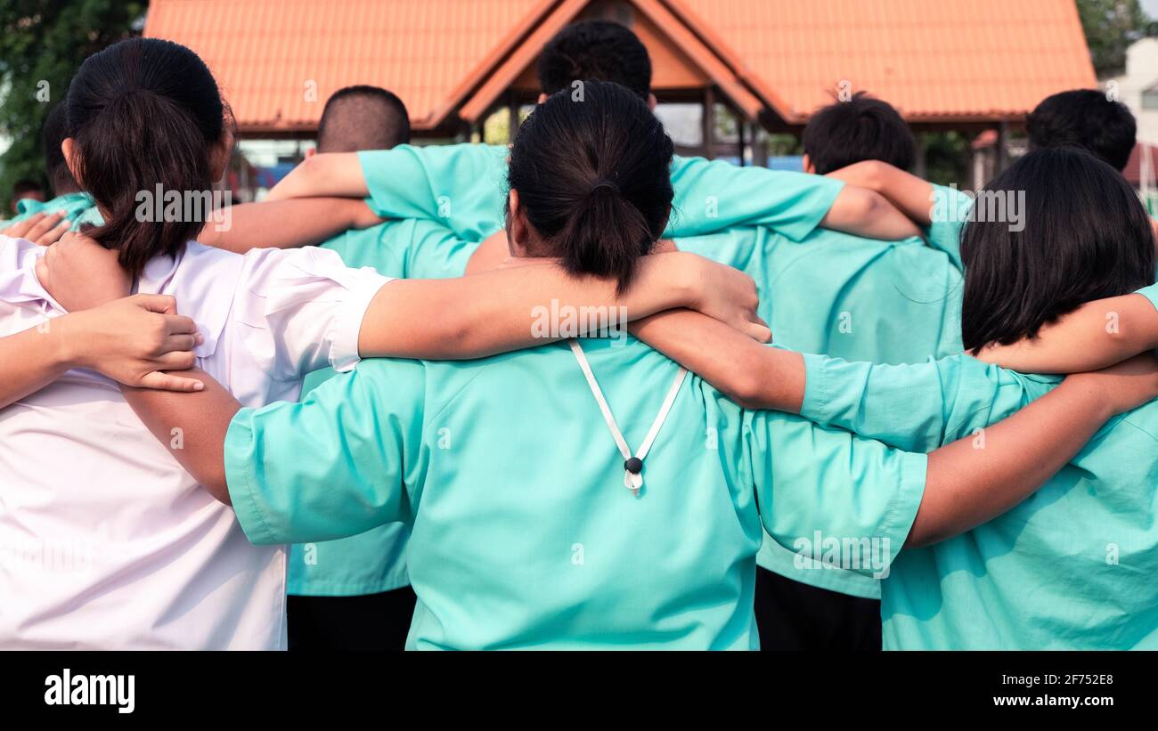 Concept of best friends,Teen group of uniform students hugging in ...