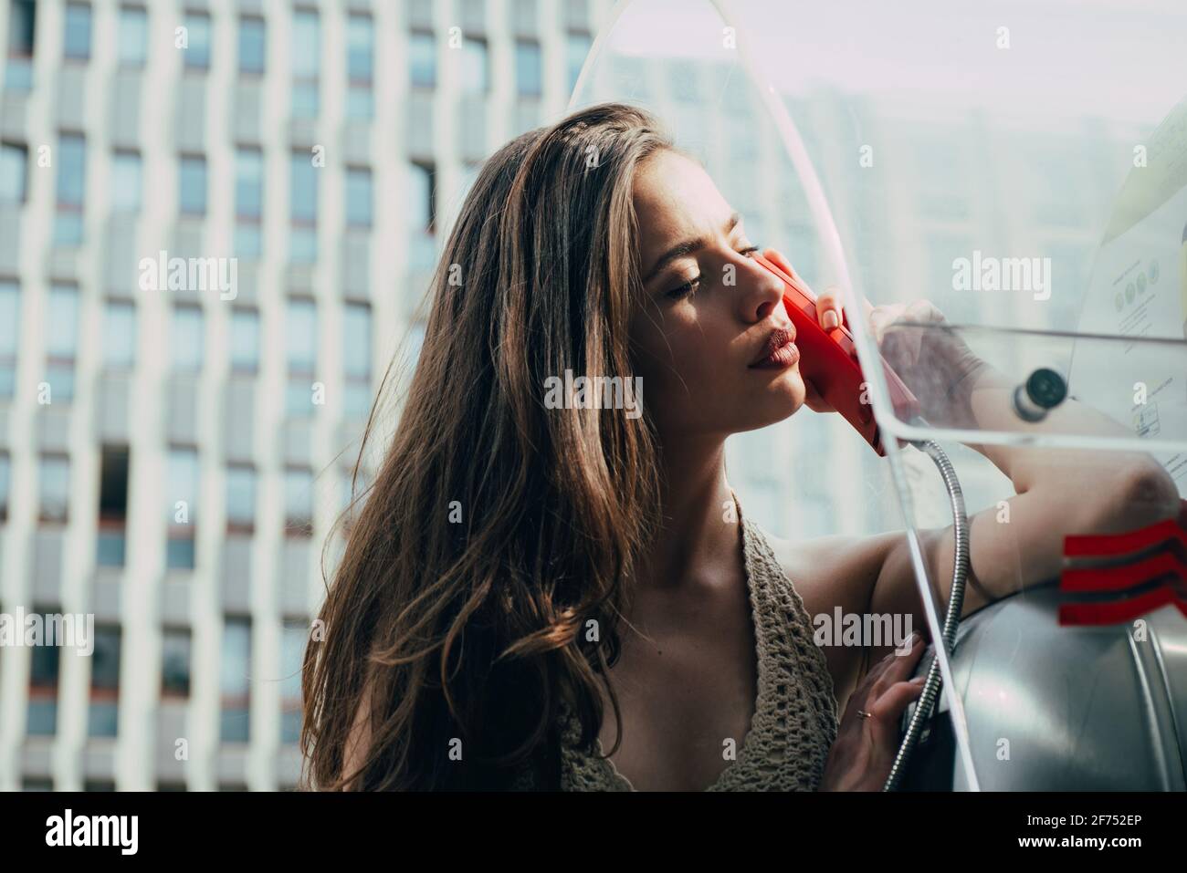 Oldfashion town. Woman with payphone. Vintage concept. Communication ...