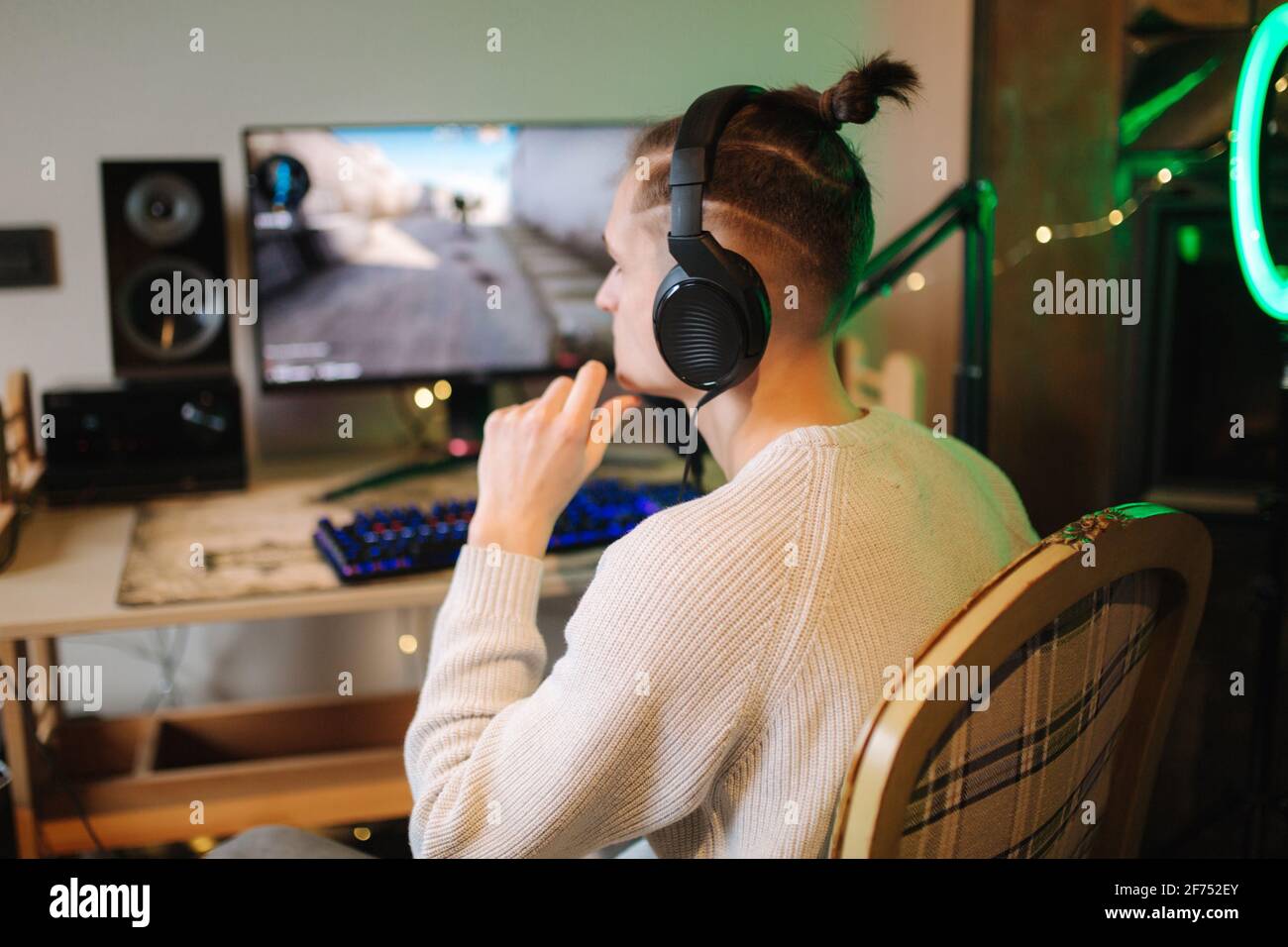 Men playing online video games at home using powerful computer ...